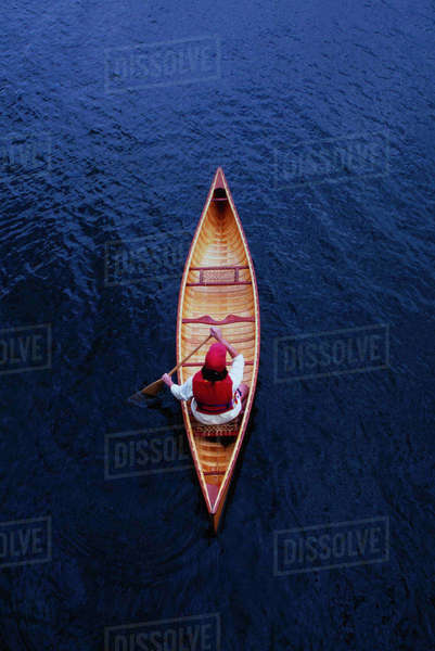 Overhead view of woman paddling canoe on Lake Placid - Stock Photo ...