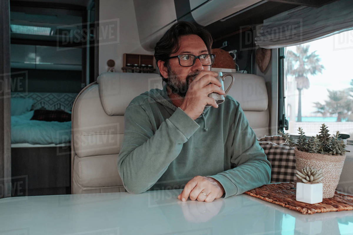 Man sitting in mobile home and drinking tea - Royalty-free Stock Photo ...