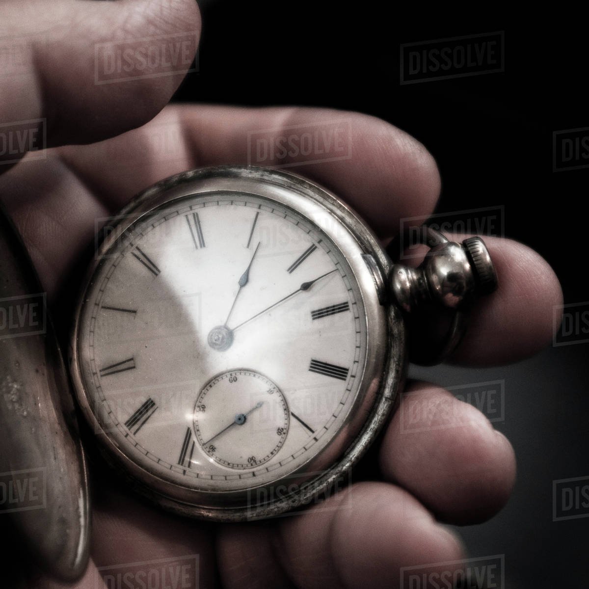Pocket watch in man's hand - Stock Photo - Dissolve
