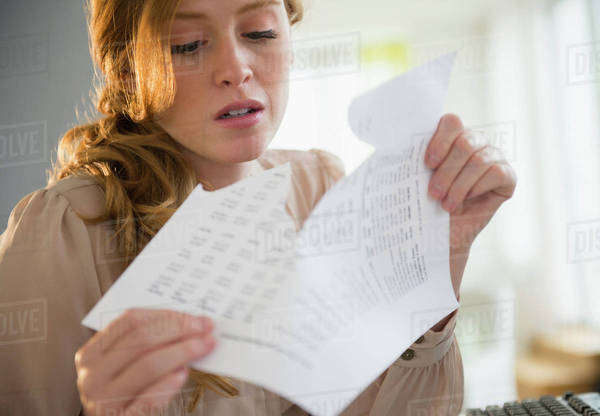 View of woman ripping documents - Stock Photo - Dissolve