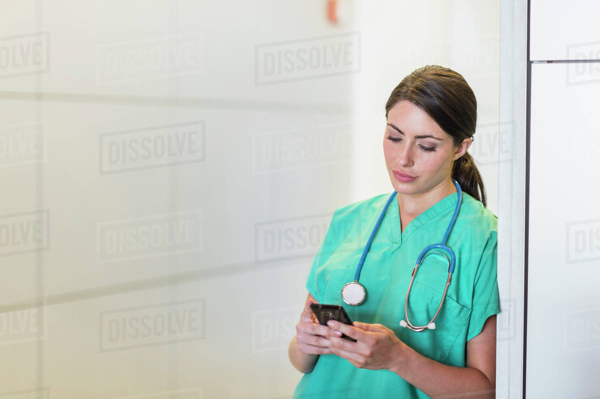 Female doctor text messaging - Royalty-free Stock Photo | Dissolve