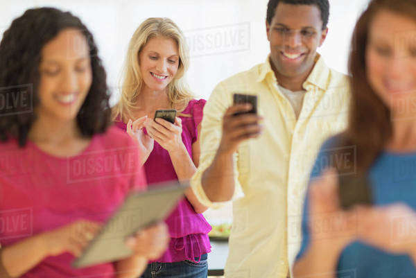 People using communication devices - Royalty-free Stock Photo | Dissolve