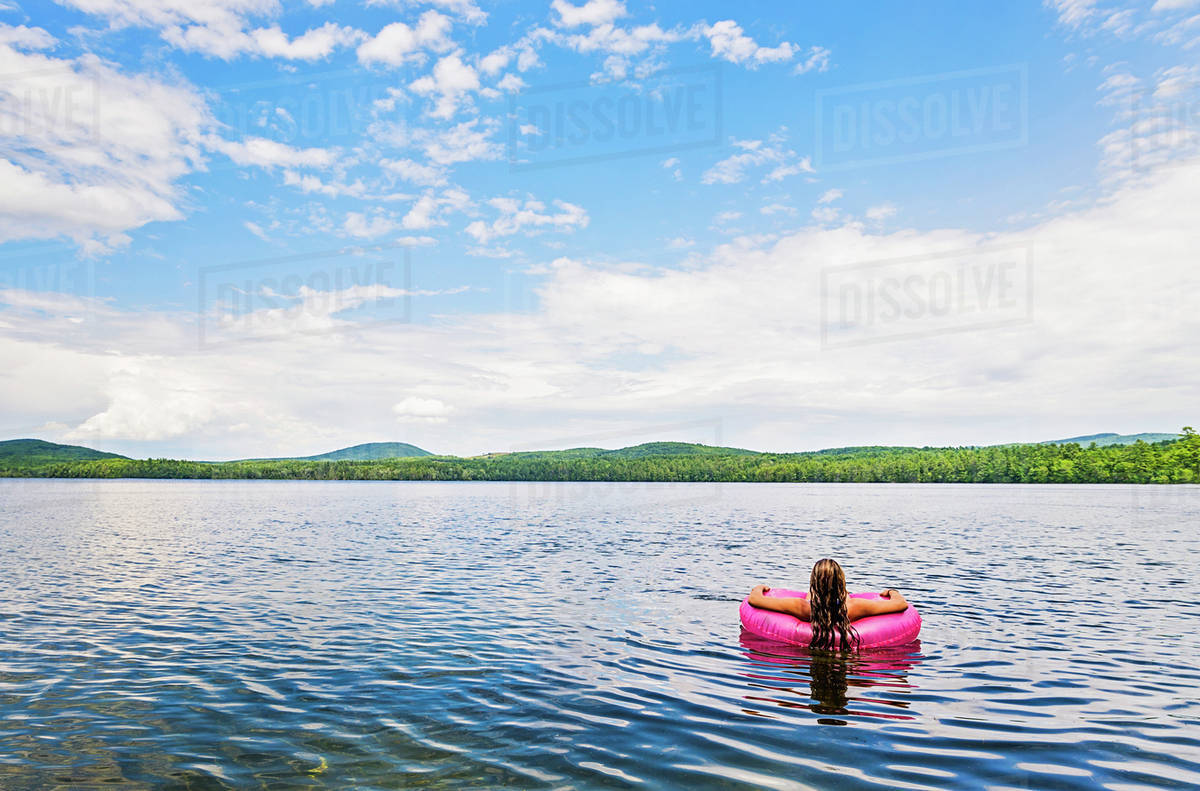 Young woman relaxing on lake in pool raft - Royalty-free Stock Photo ...