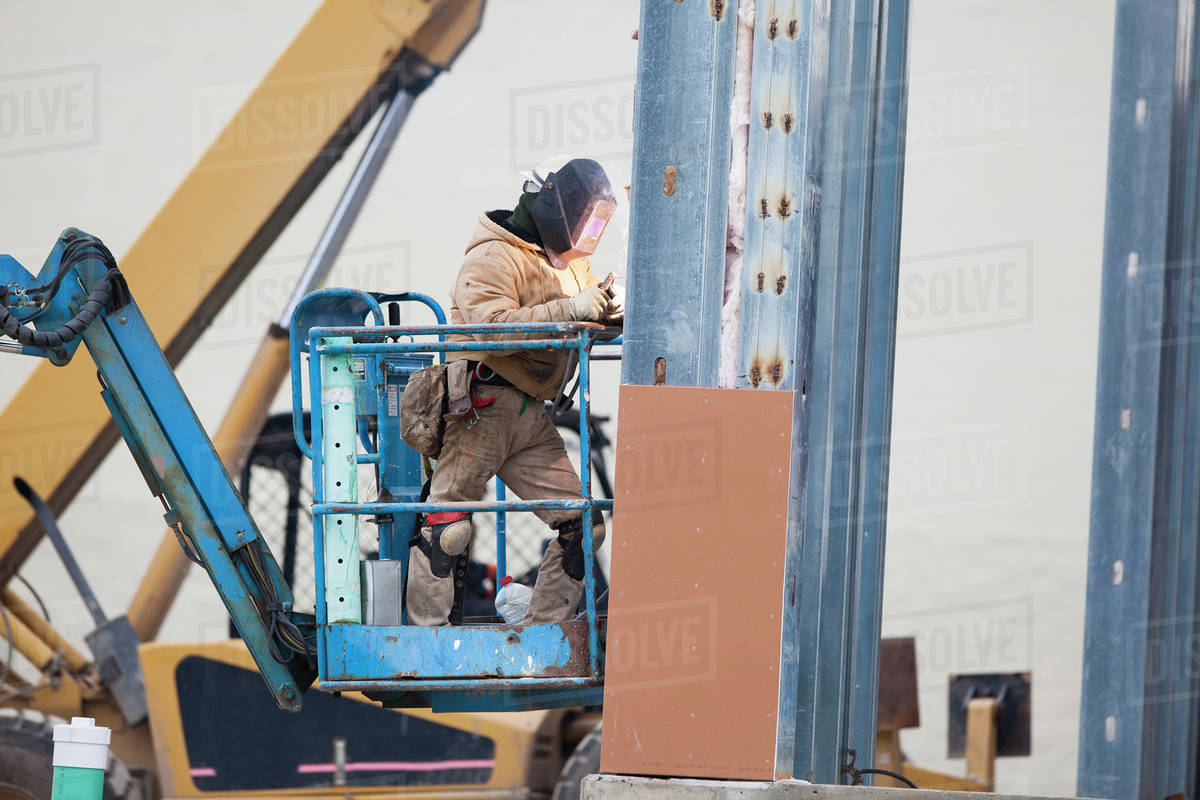 Men welding steel bar - Stock Photo - Dissolve