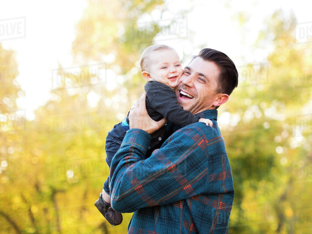 Father hugging baby son (6-11 months) - Royalty-free Stock Photo | Dissolve