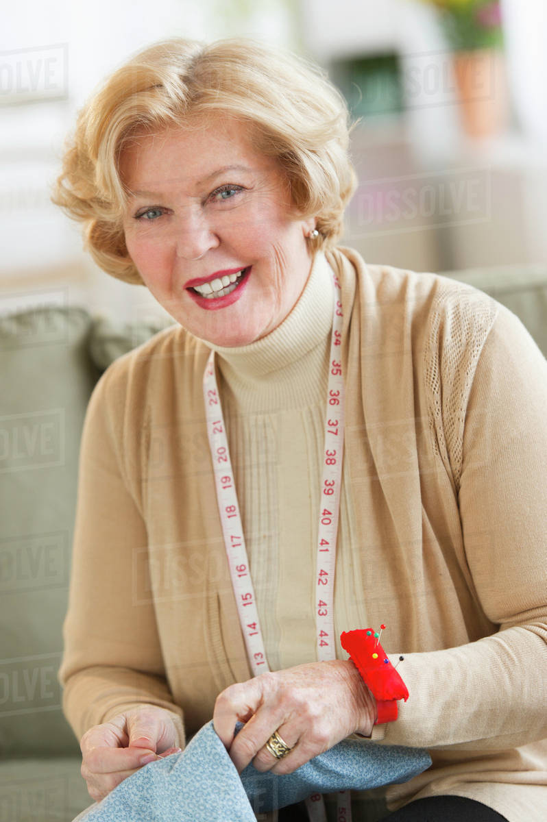 Portrait of senior woman sewing - Royalty-free Stock Photo | Dissolve