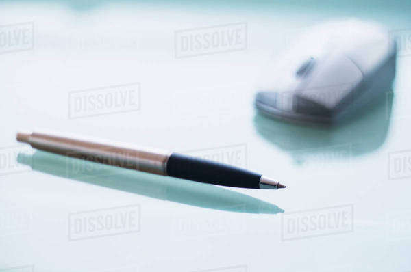 Pen and computer mouse - Stock Photo - Dissolve