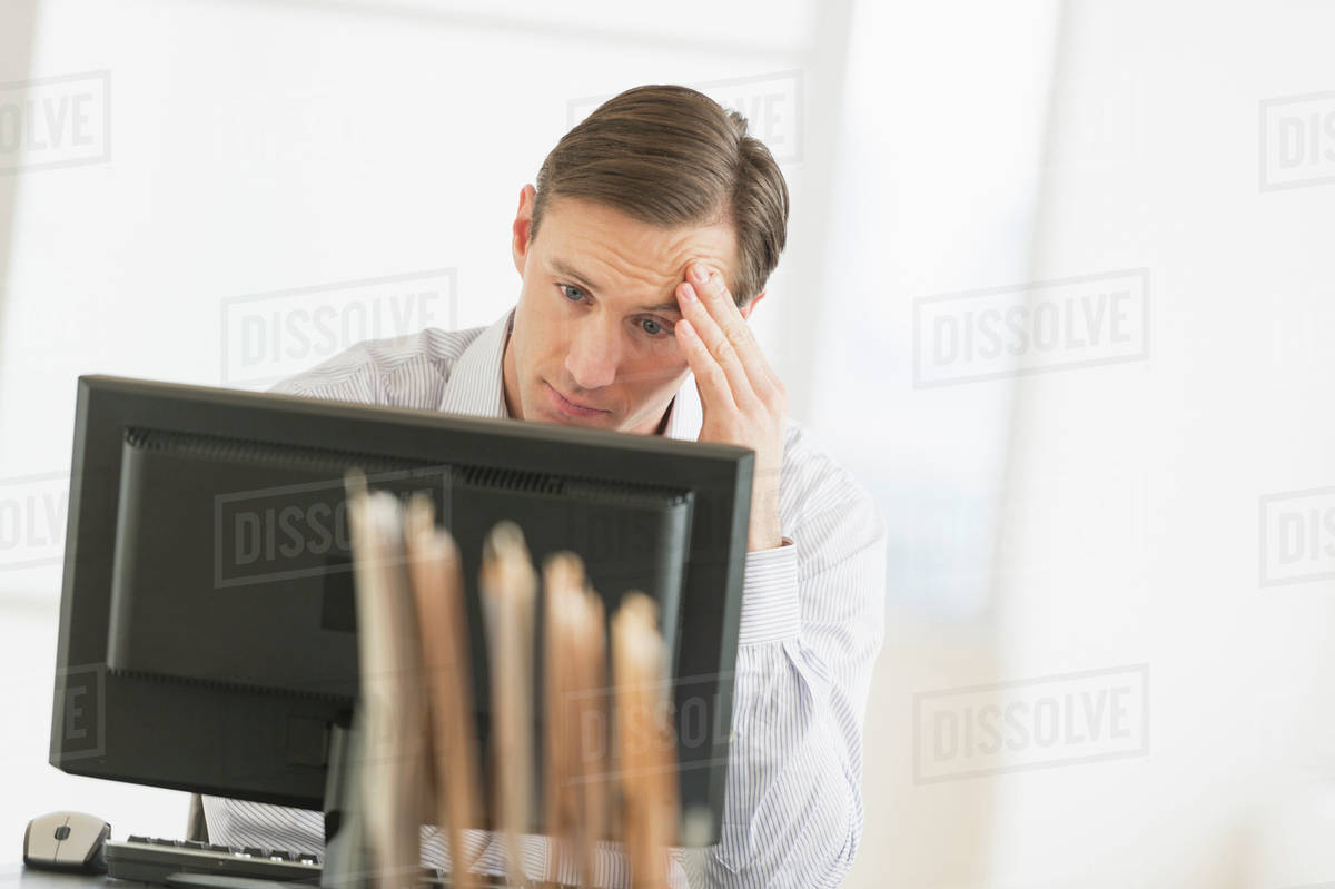 Office worker using computer - Royalty-free Stock Photo | Dissolve