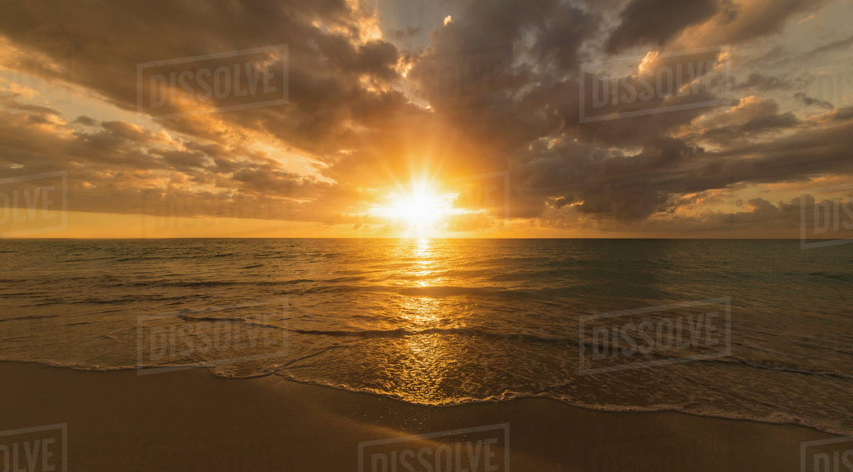 Sun setting over sea - Royalty-free Stock Photo | Dissolve