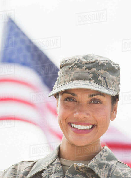 Portrait of female army soldier, American flag in background - Royalty ...
