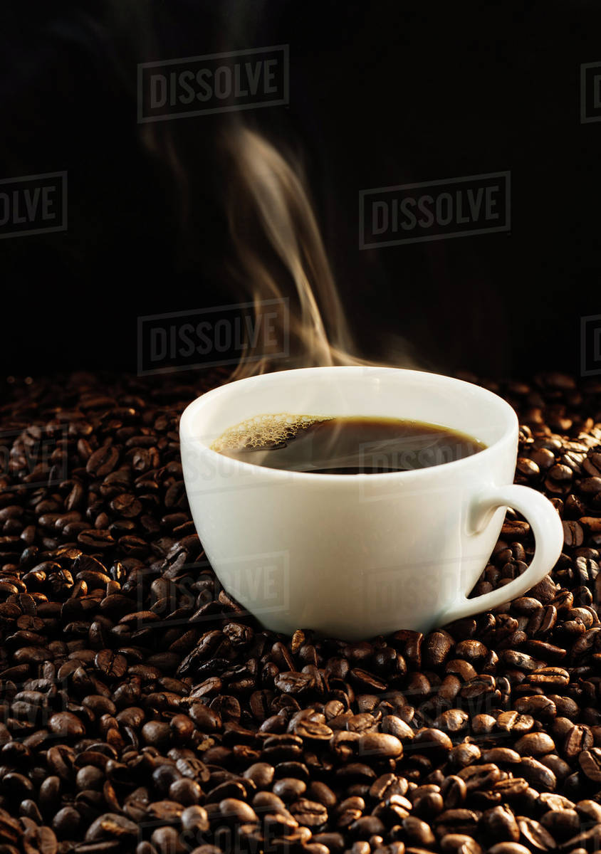 Hot coffee and coffee beans, studio shot - Royalty-free Stock Photo ...