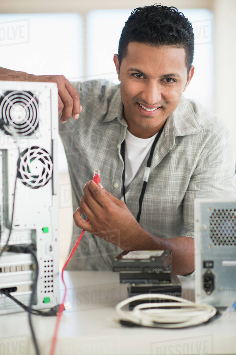 Man repairing computer - Stock Photo - Dissolve