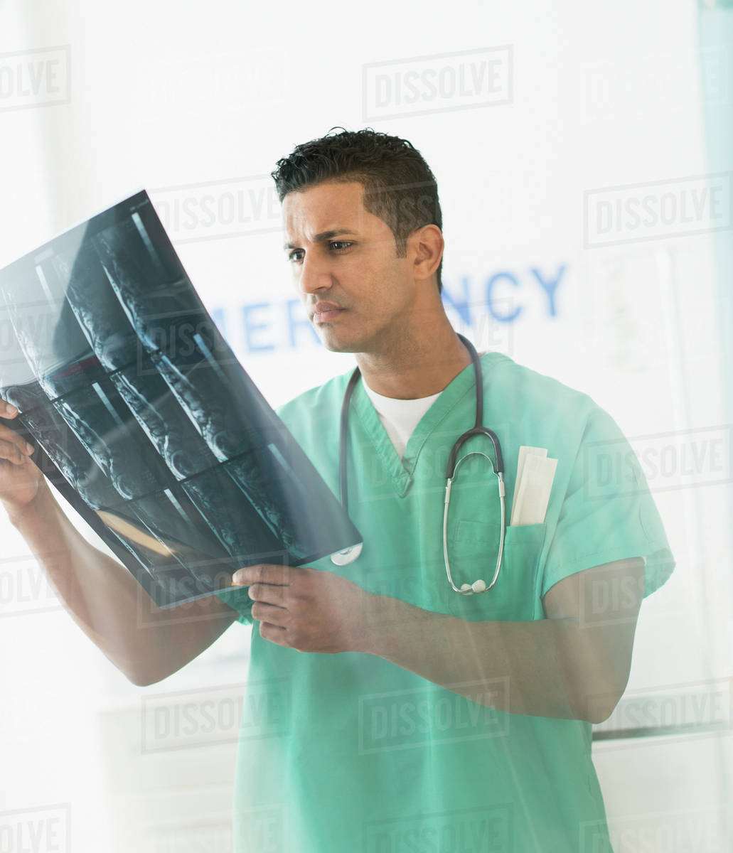 Doctor looking at x-ray image - Royalty-free Stock Photo | Dissolve