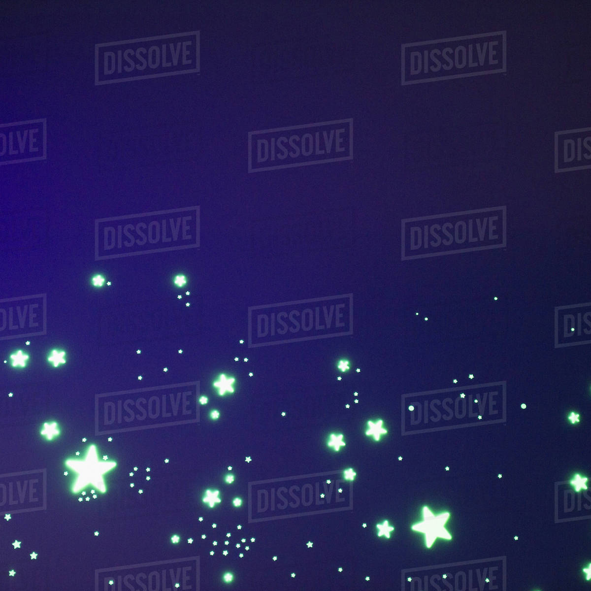 Fluorescent stars on blue background, studio shot - Stock Photo - Dissolve
