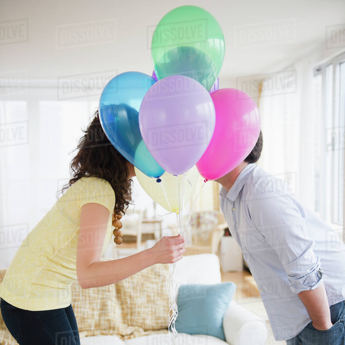 Couple kissing behind bunch of colorful balloons - Royalty-free Stock ...