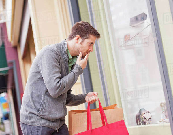 Man looking at window display - Royalty-free Stock Photo | Dissolve
