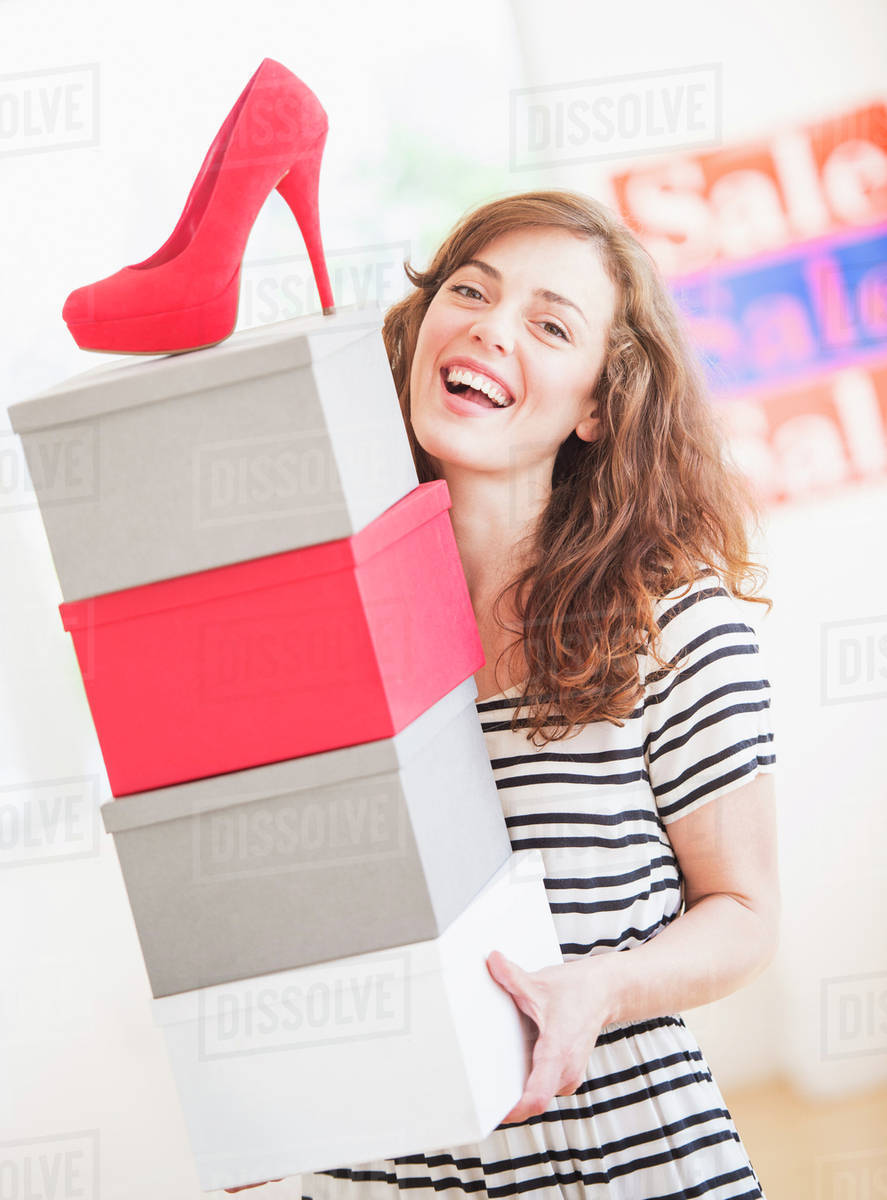 Woman carrying shoes boxes - Royalty-free Stock Photo | Dissolve