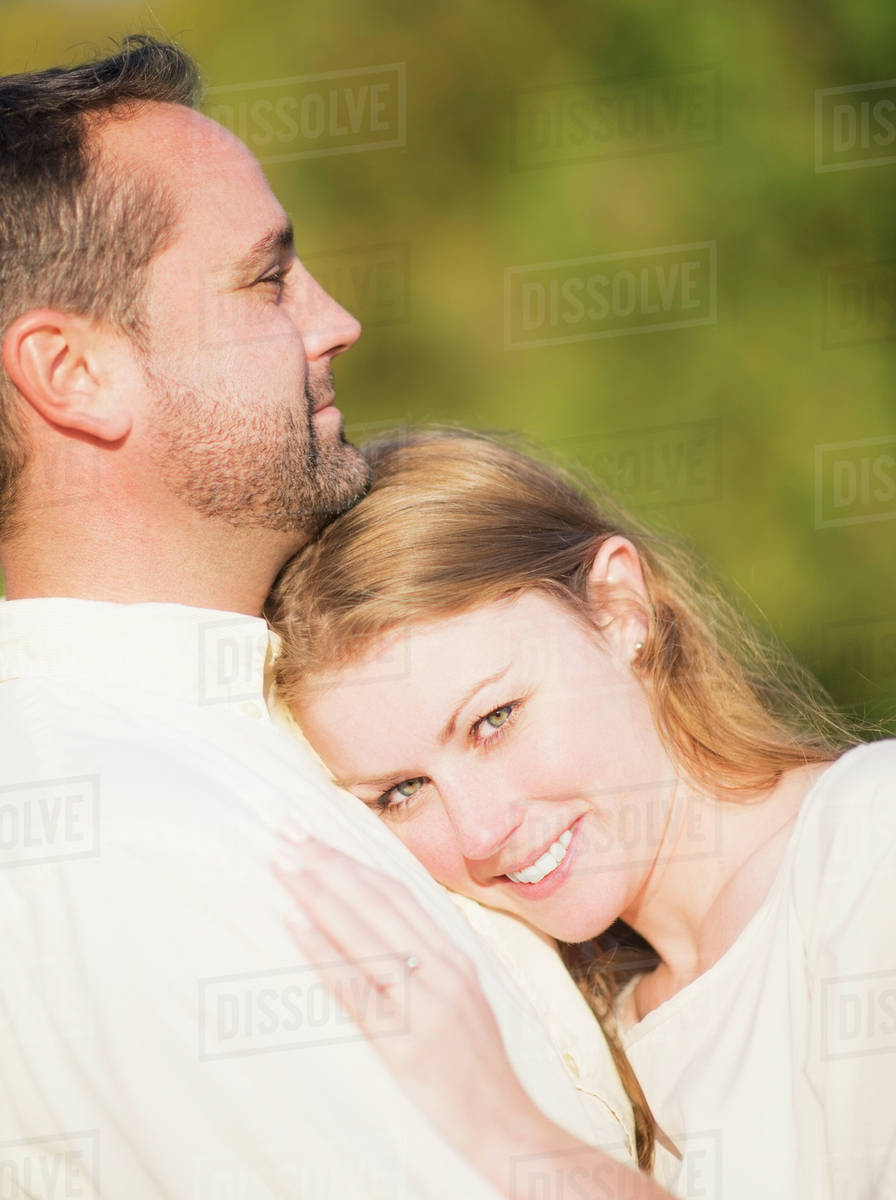 Couple embracing in park - Royalty-free Stock Photo | Dissolve