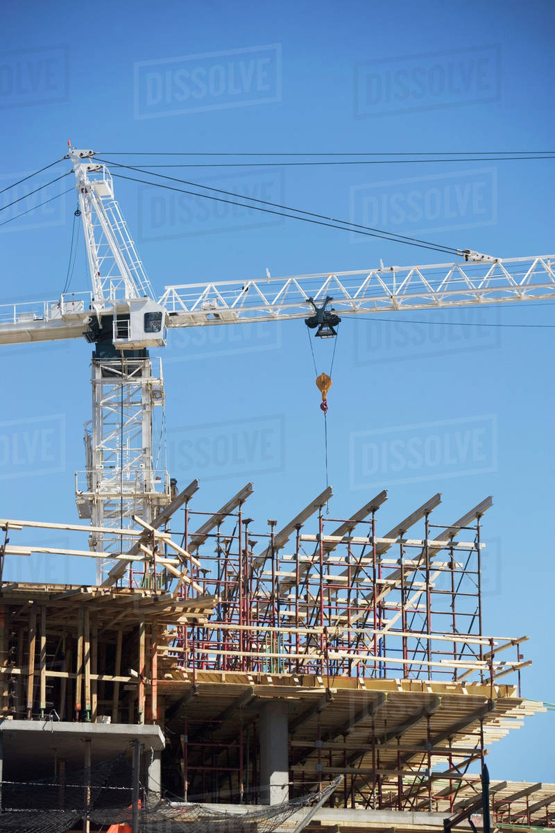 Crane on construction site - Royalty-free Stock Photo | Dissolve