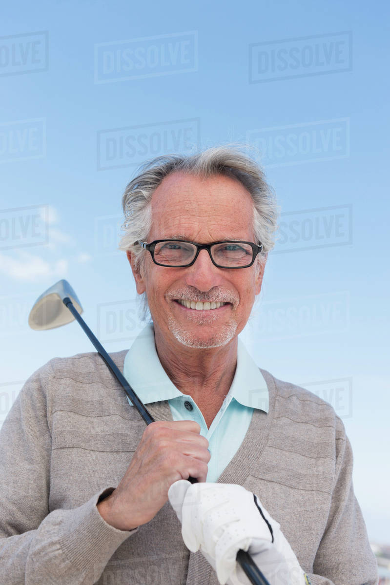 Senior man holding golf club - Royalty-free Stock Photo | Dissolve