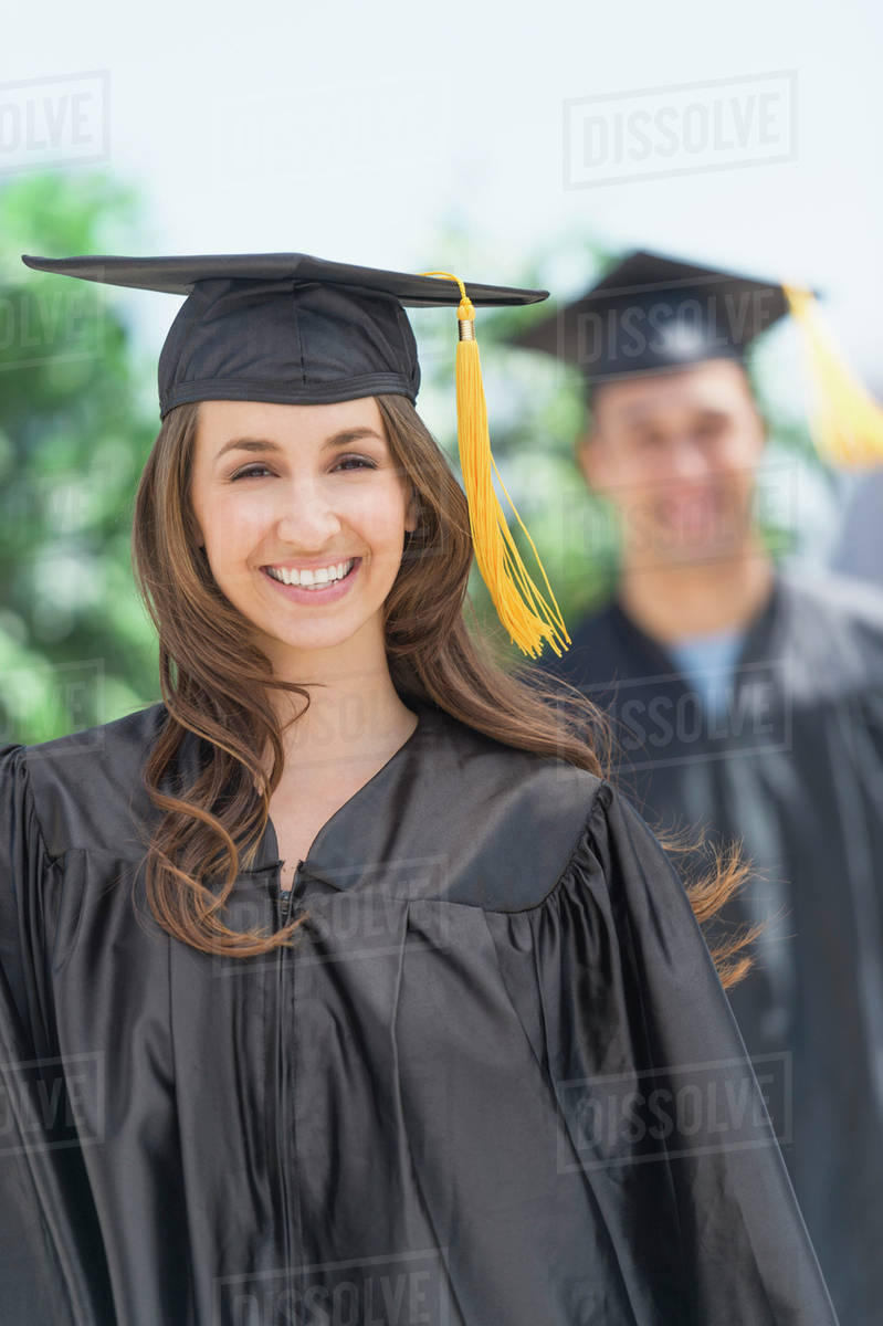 Female and male student on graduation ceremony - Stock Photo - Dissolve