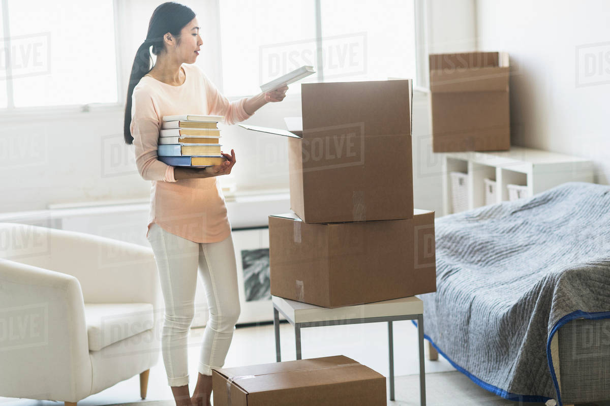 Woman moving home - Royalty-free Stock Photo | Dissolve