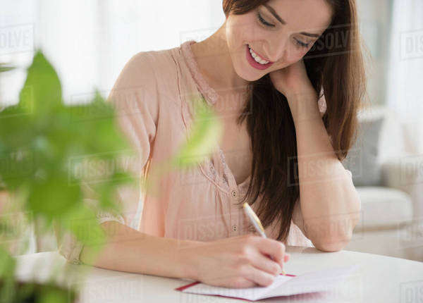 Young woman writing letter - Royalty-free Stock Photo | Dissolve