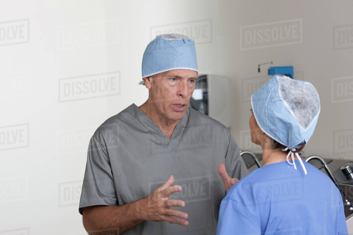Male and female surgeons talking - Royalty-free Stock Photo | Dissolve