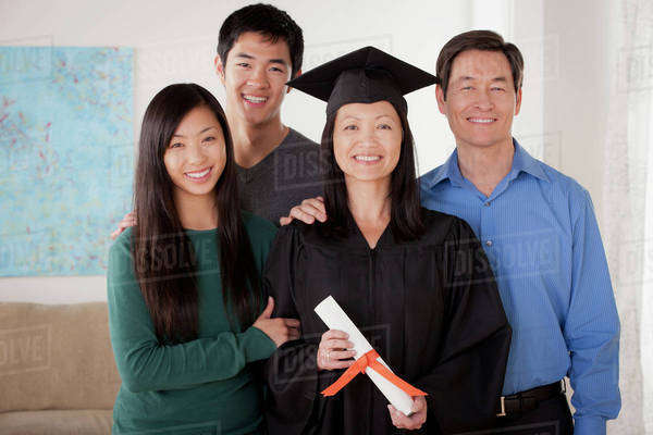 Portrait of young man in graduation gown with family - Royalty-free ...