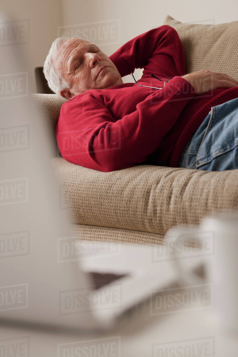 Senior man sleeping on sofa - Royalty-free Stock Photo | Dissolve