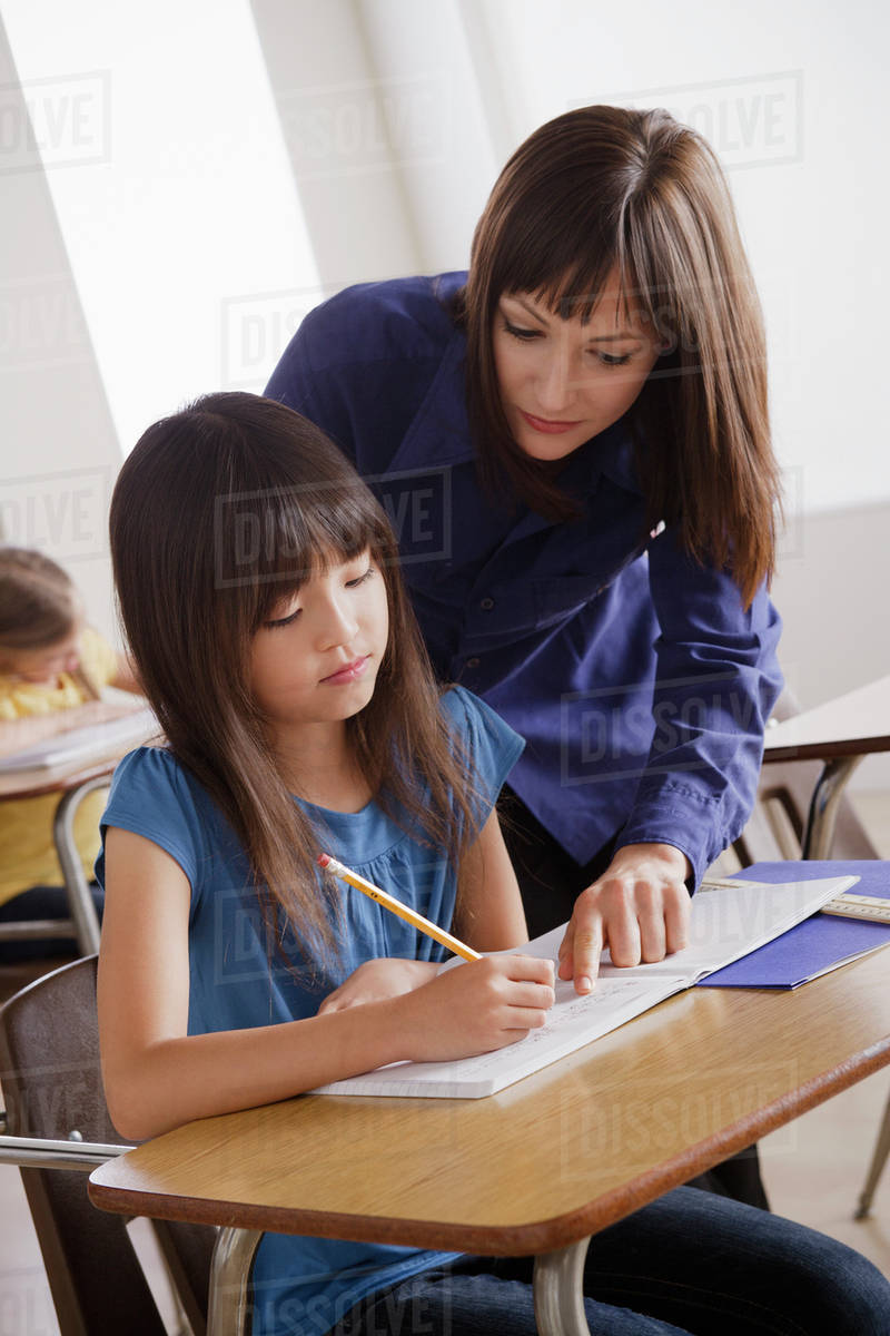 Schoolgirl with teacher - Royalty-free Stock Photo | Dissolve
