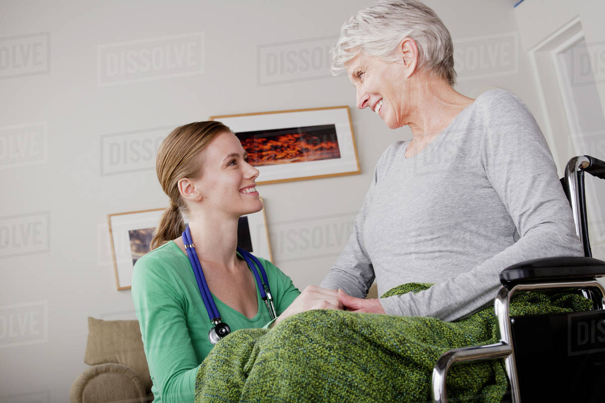 Young female nurse taking care of senior woman - Stock Photo - Dissolve