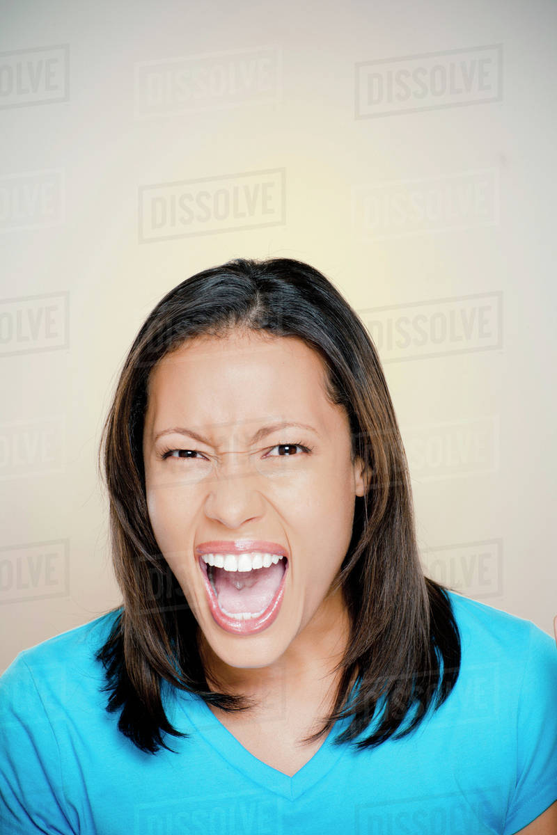 Portrait of woman screaming - Stock Photo - Dissolve