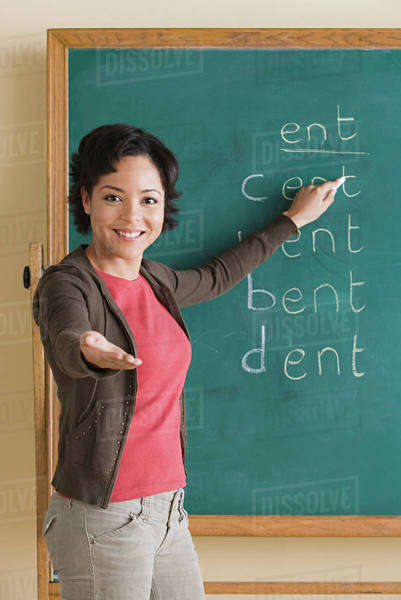 Teacher showing words on blackboard - Royalty-free Stock Photo | Dissolve