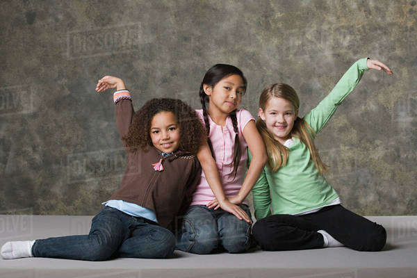 Three girls (8-9) posing, studio shot - Royalty-free Stock Photo | Dissolve