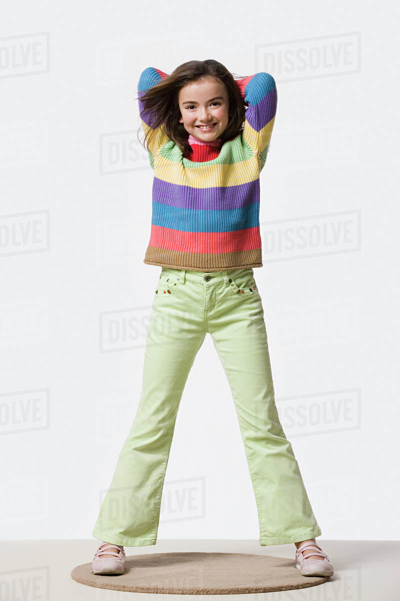 Studio portrait of smiling girl (8-9) - Royalty-free Stock Photo | Dissolve