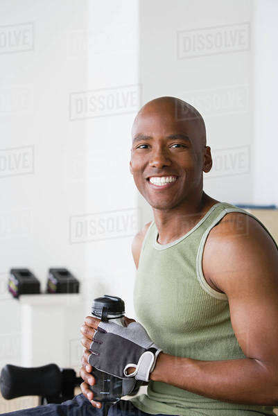 Portrait of smiling young man in gym - Royalty-free Stock Photo | Dissolve