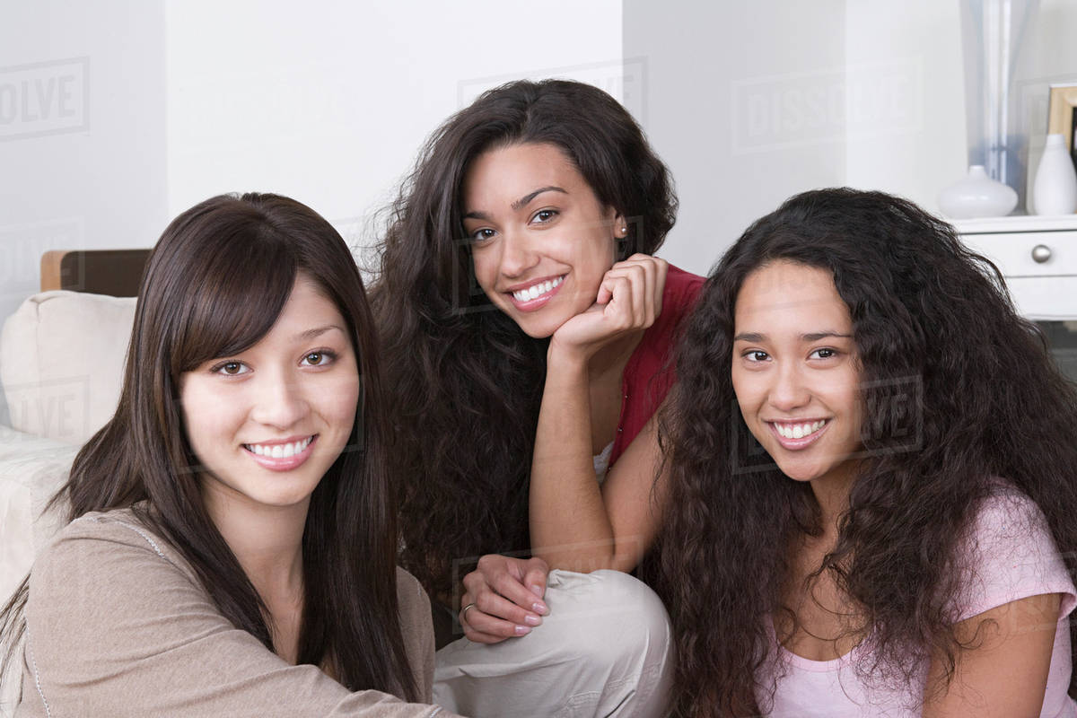 Portrait of three young women smiling - Stock Photo - Dissolve