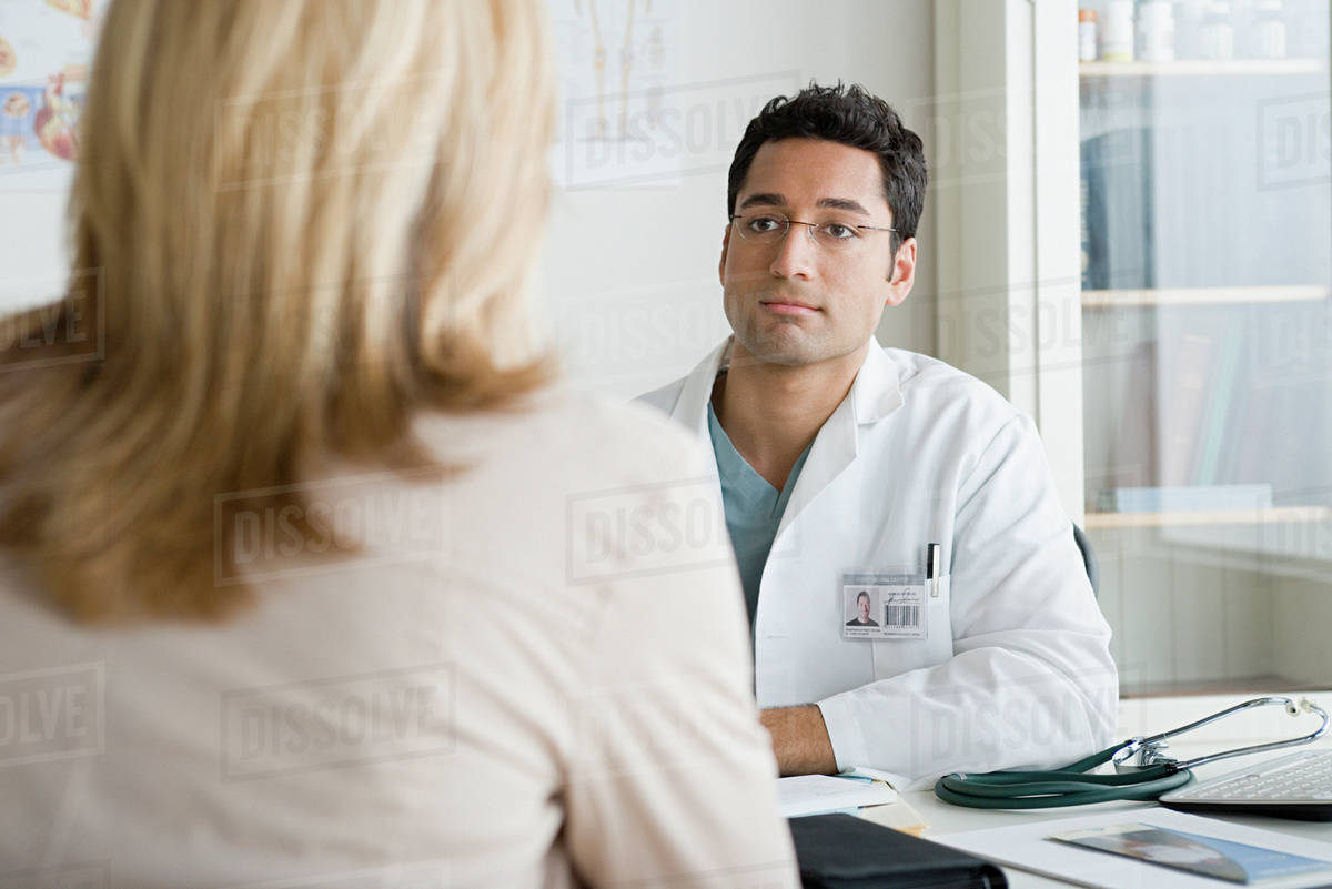 Doctor listening to patient - Royalty-free Stock Photo | Dissolve