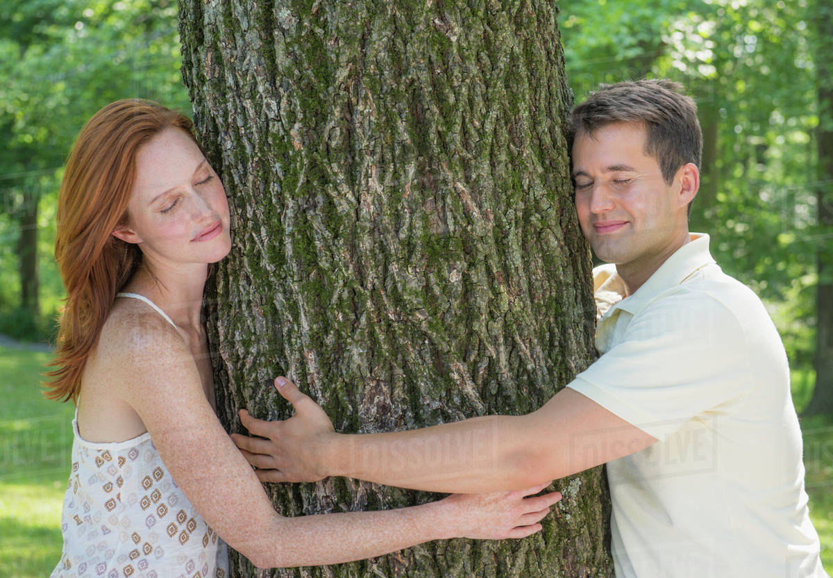 Couple embracing tree - Royalty-free Stock Photo | Dissolve