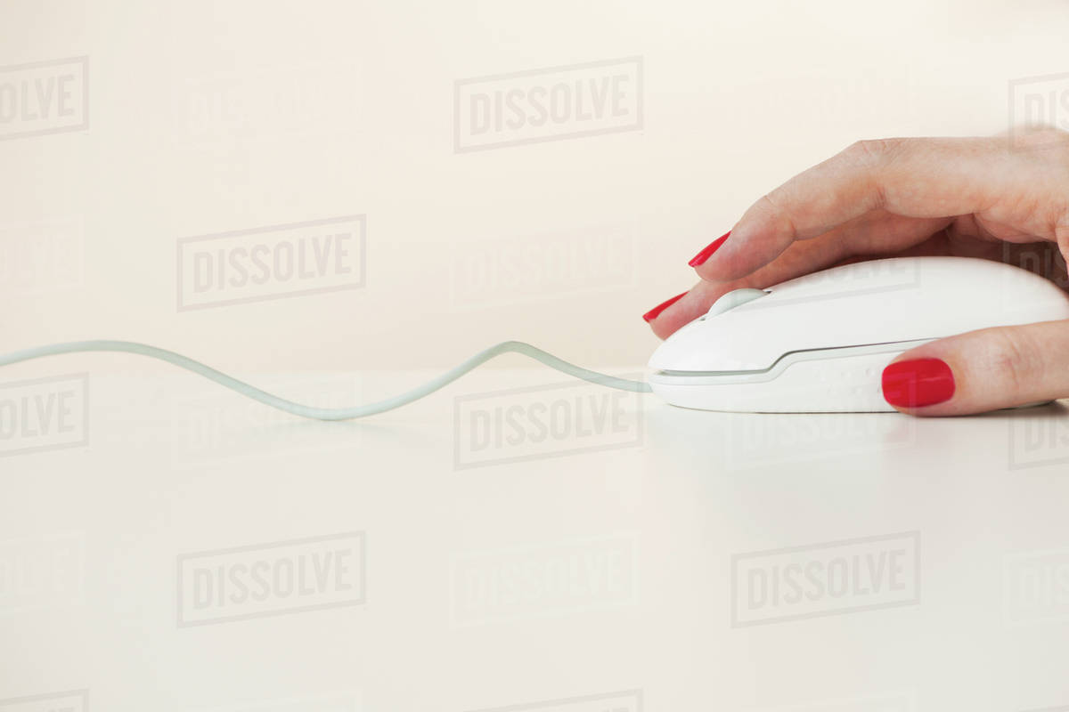 Close up of woman's hand with red nail polish holding computer mouse ...