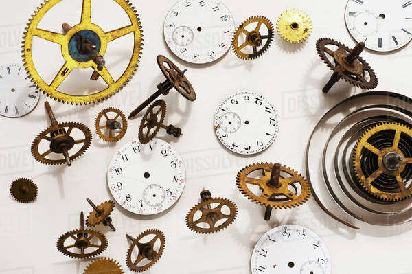 Close up of gears and clock parts on white background - Stock Photo ...