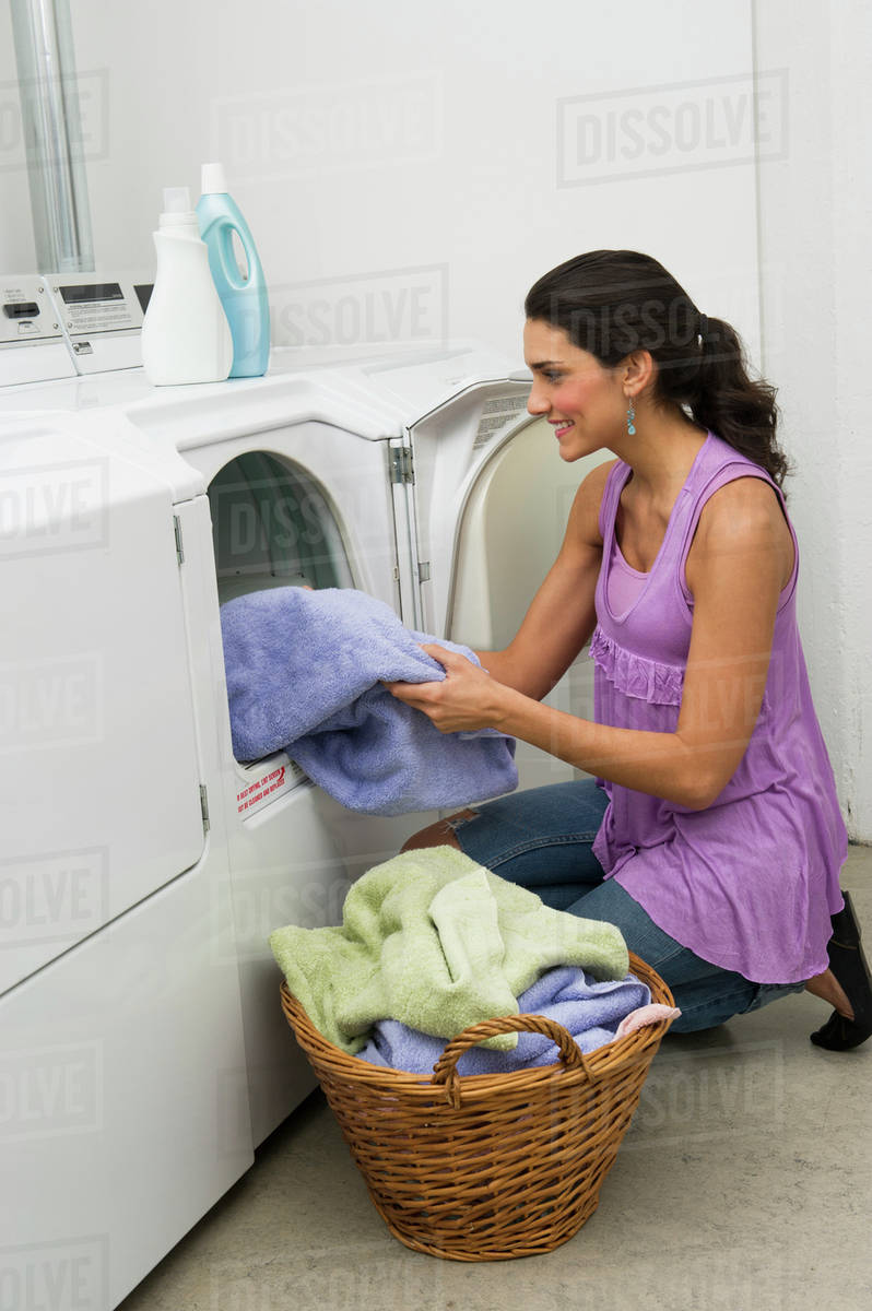 Woman doing laundry - Stock Photo - Dissolve