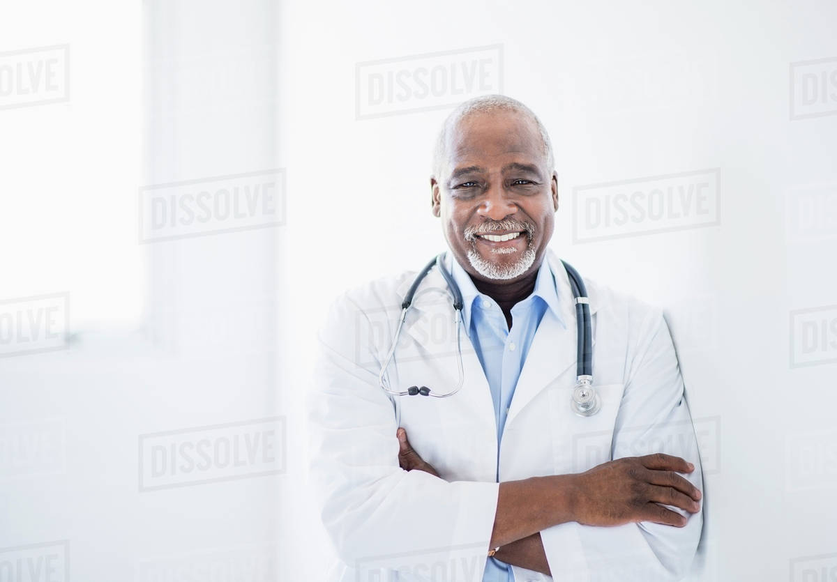 Portrait of doctor with arms crossed - Royalty-free Stock Photo | Dissolve