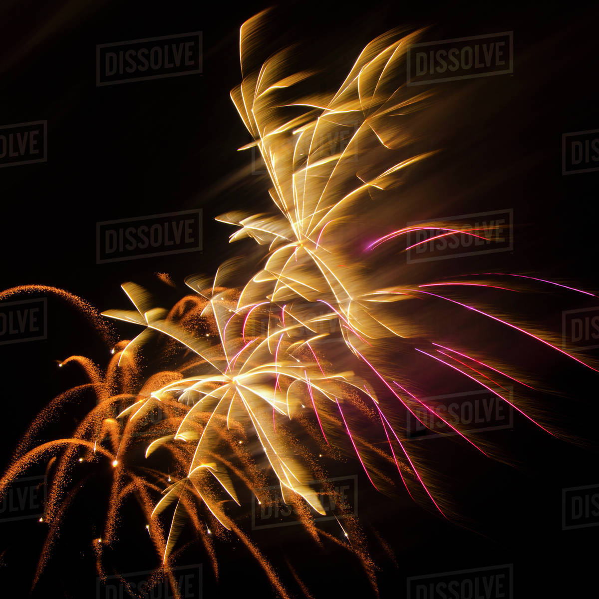 Fireworks explosion against night sky - Royalty-free Stock Photo | Dissolve