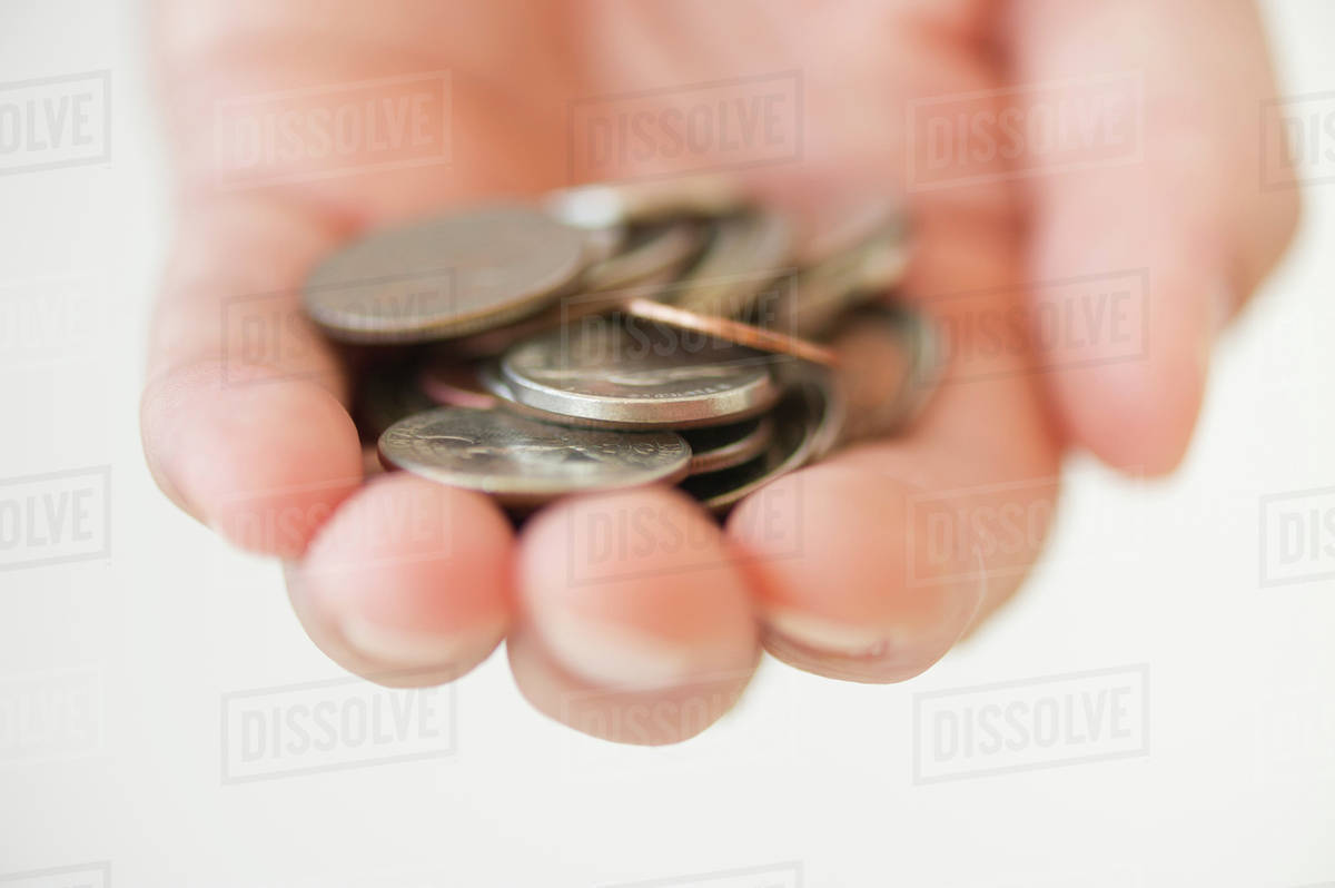 Hand holding coins - Royalty-free Stock Photo | Dissolve