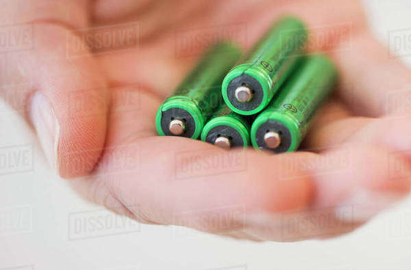 Hand holding batteries - Royalty-free Stock Photo | Dissolve