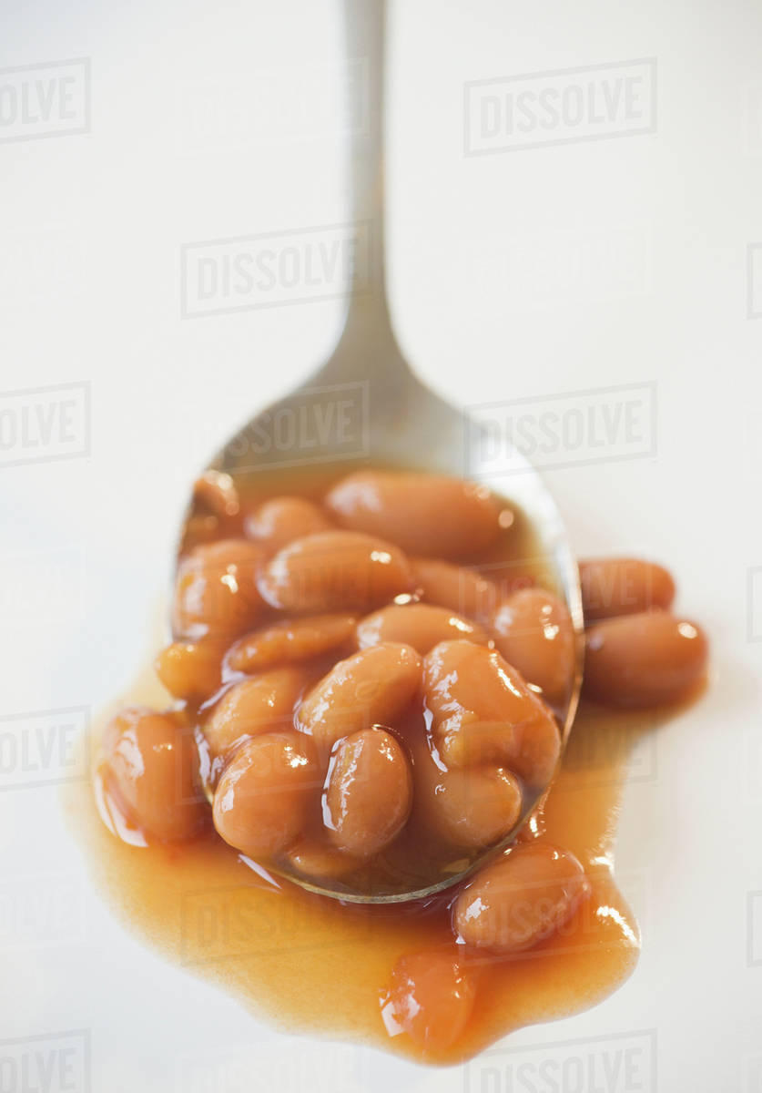 Close up of baked beans on spoon - Royalty-free Stock Photo | Dissolve