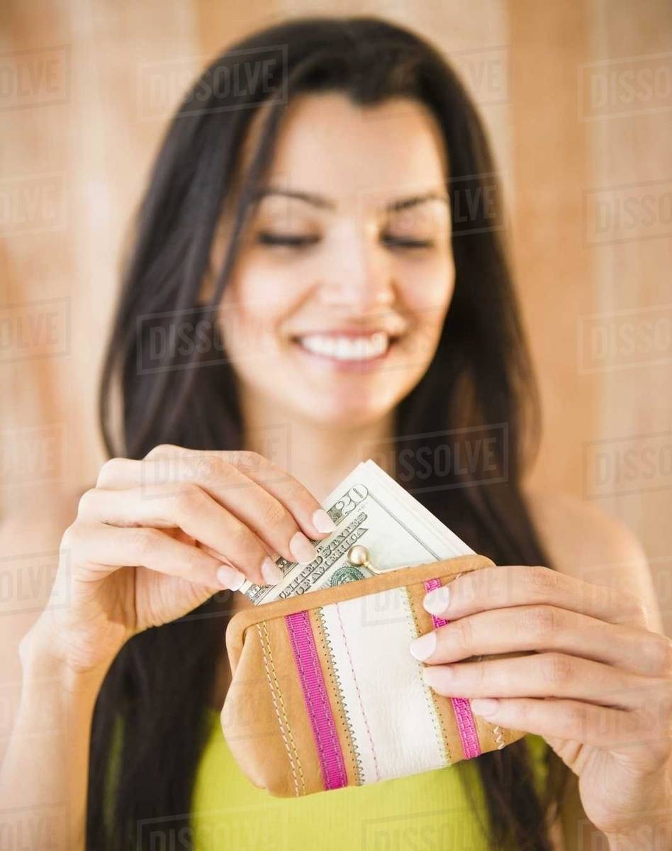 Portrait of smiling woman taking money from purse - Royalty-free Stock ...