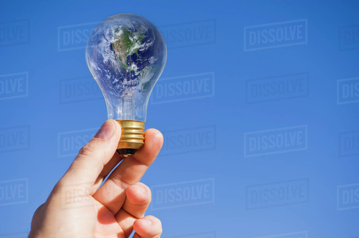 Hand holding lightbulb with globe - Royalty-free Stock Photo | Dissolve